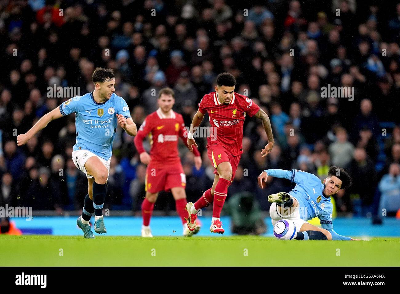 Liverpool's Luis Diaz battle for the ball with Manchester City's Rico ...