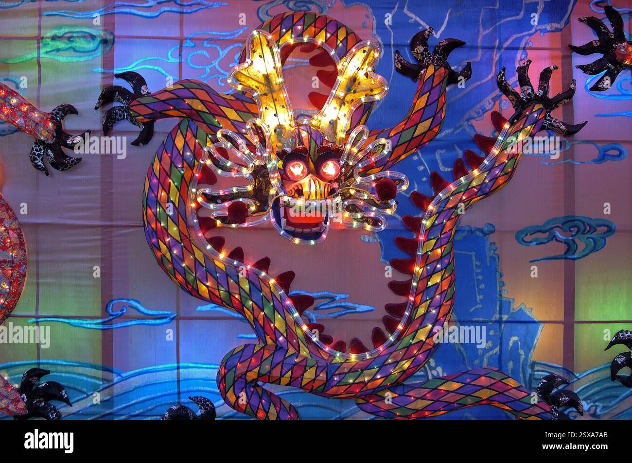 A puppet made of bamboo and paper in shape of a dragon adorned with LED ...