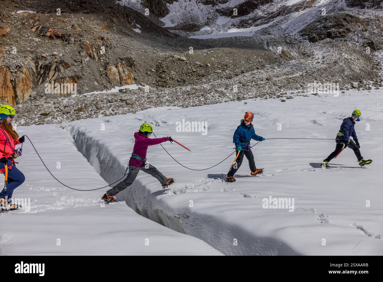 Alpine climbers rope team on a glacier in Chamonix valley training the ...