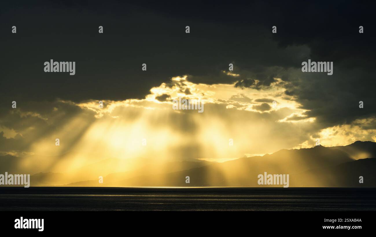 Sun rays in the clouds over Sicily, Tyrrhenian Sea, Italy Stock Photo ...