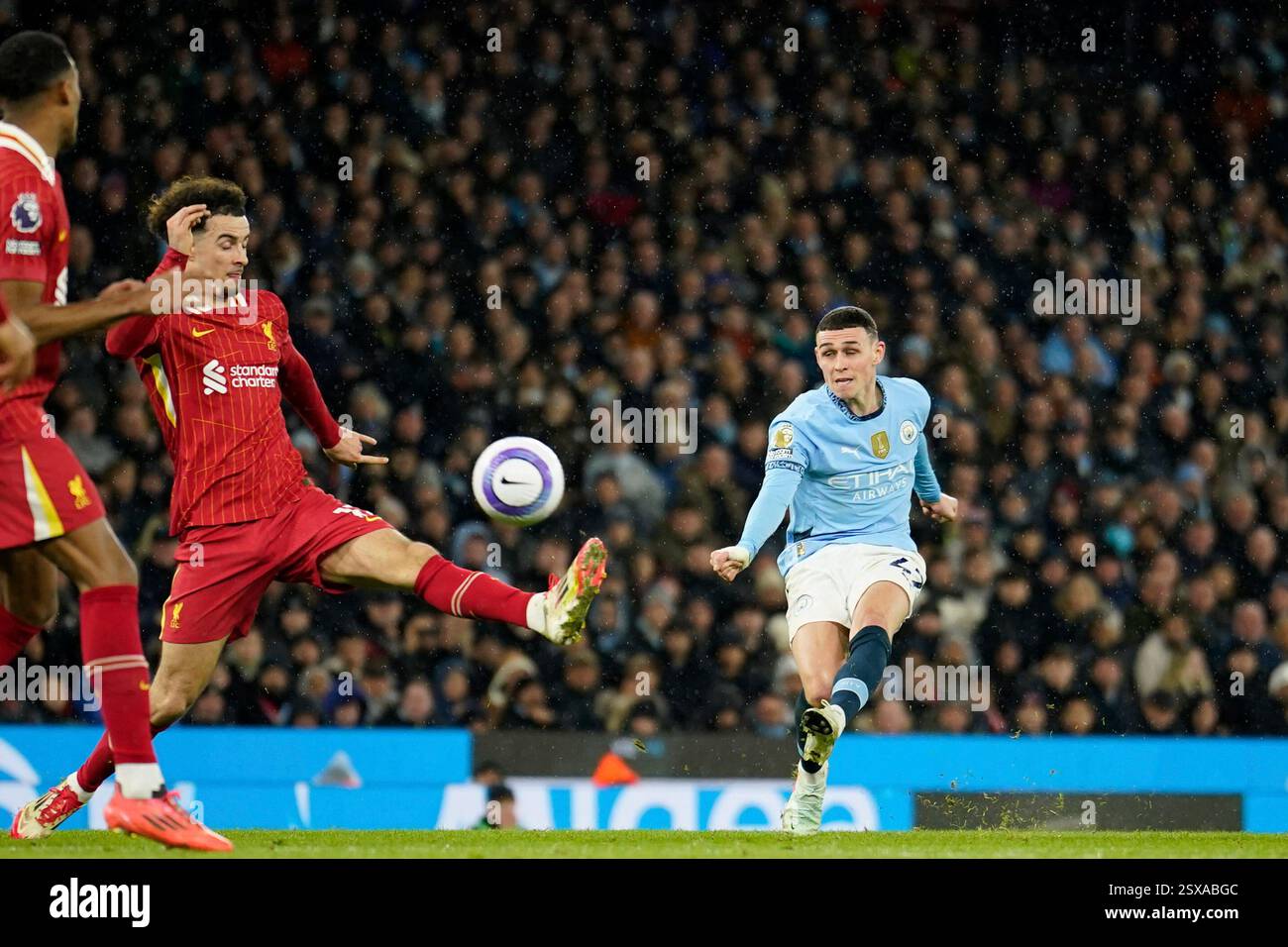 Manchester City's Phil Foden, right, attempts a shot on goal during the ...