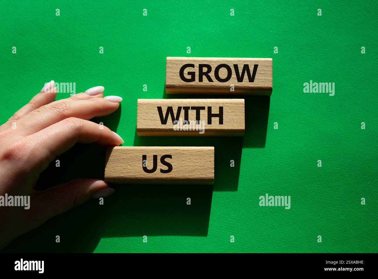 Grow with us symbol. Wooden blocks with words Grow with us. Beautiful ...