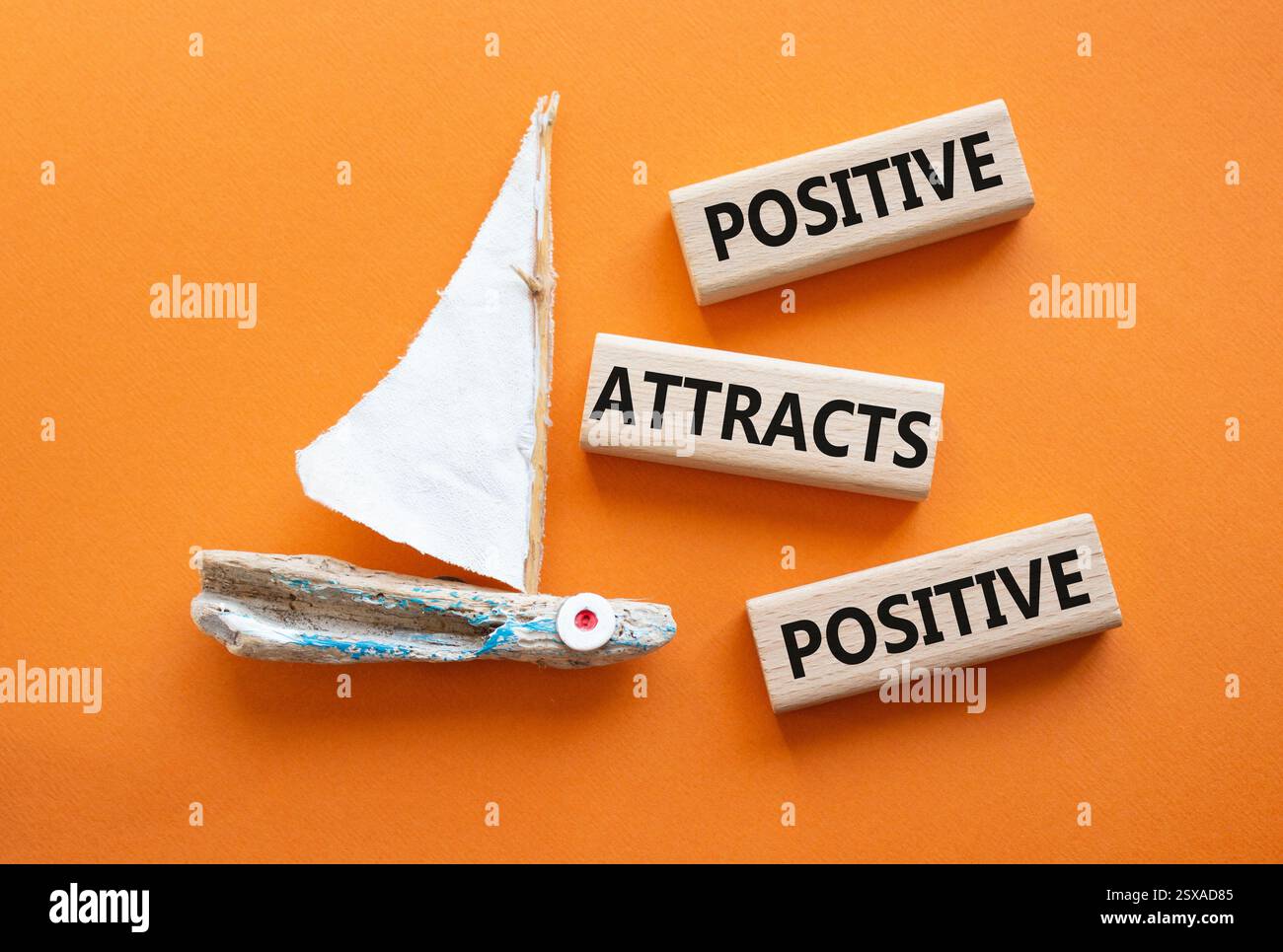 Positive attracts Positive symbol. Wooden blocks with words Positive ...