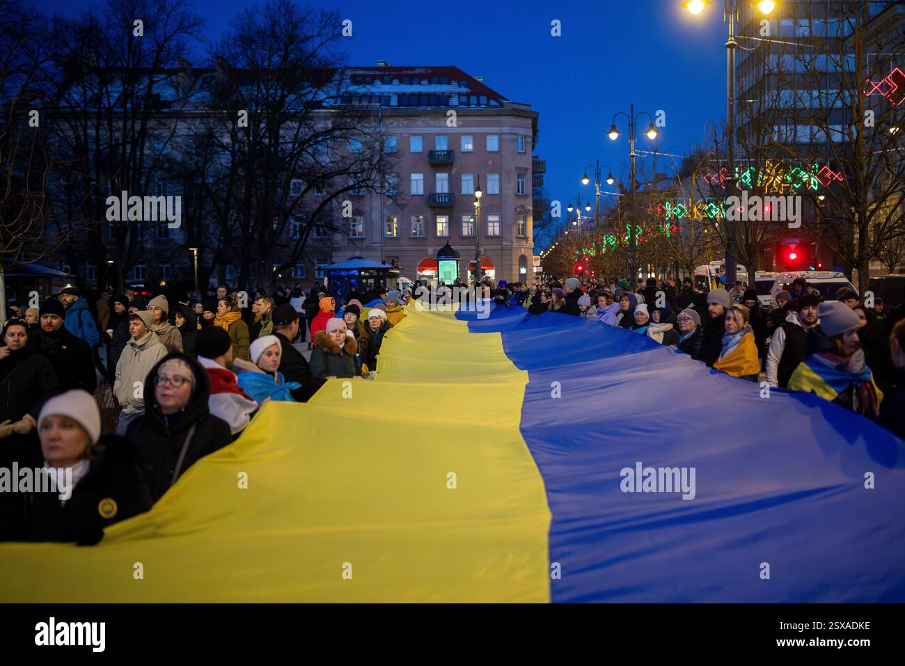 People carry a giant Ukrainian flag to mark the third anniversary of ...