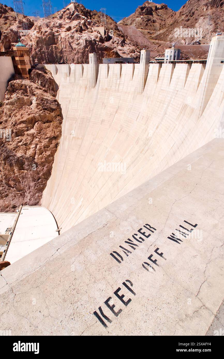Large dam with a warning sign that says Danger Keep Off Wall. The sign ...