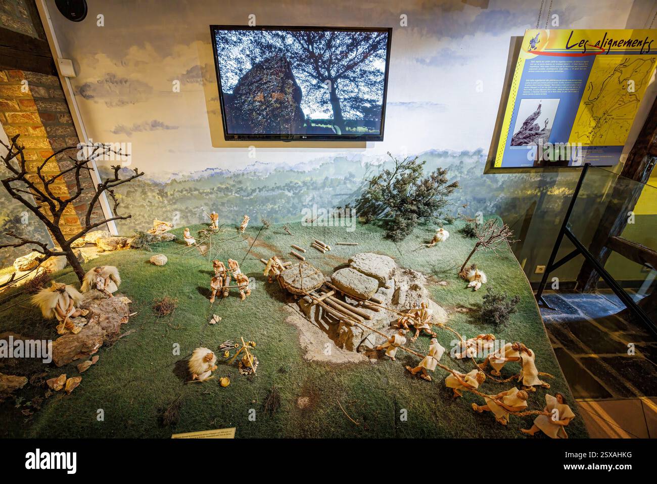 Model of prehistoric man building a dolmen, Maison des Megalithes ...