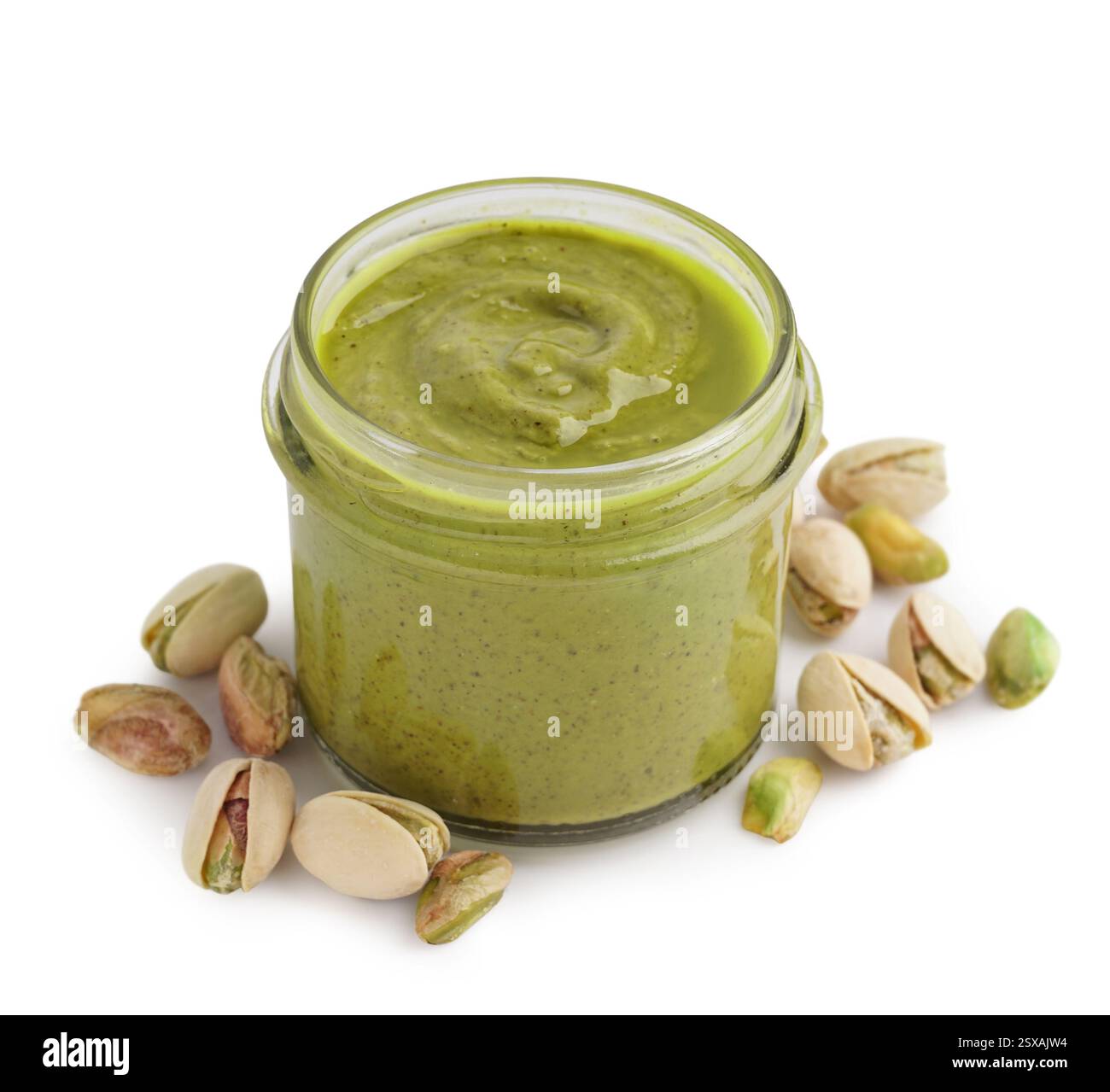 Tasty pistachio paste in jar on white background Stock Photo - Alamy