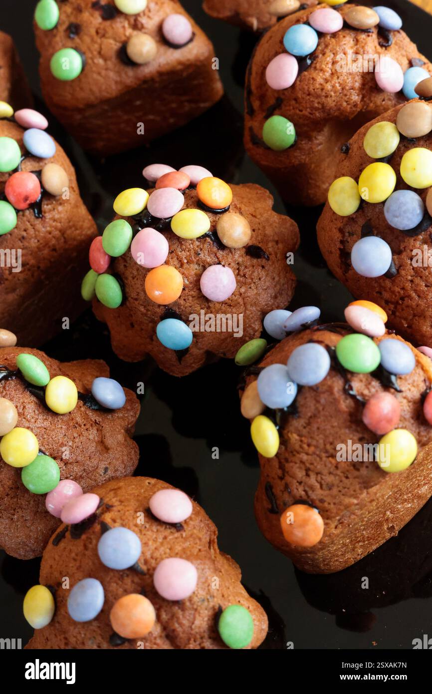 Homemade baked and decorated muffins with colorful chocolate candies ...