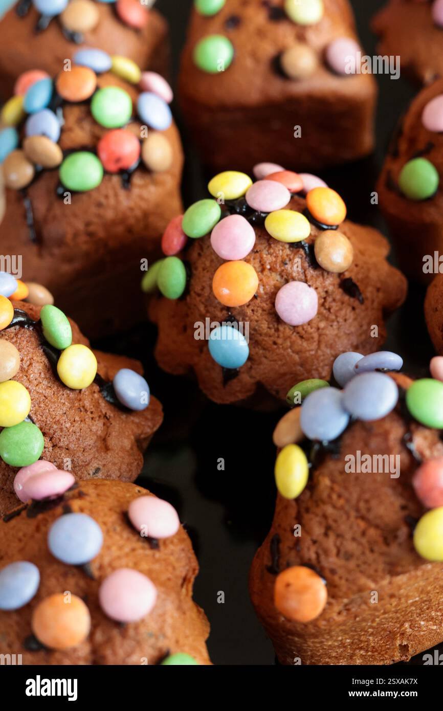 Homemade baked and decorated muffins with colorful chocolate candies ...