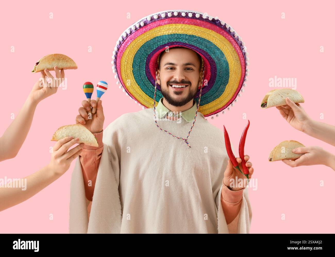 Young Mexican man with maracas, chilli and hands holding tasty tacos on ...
