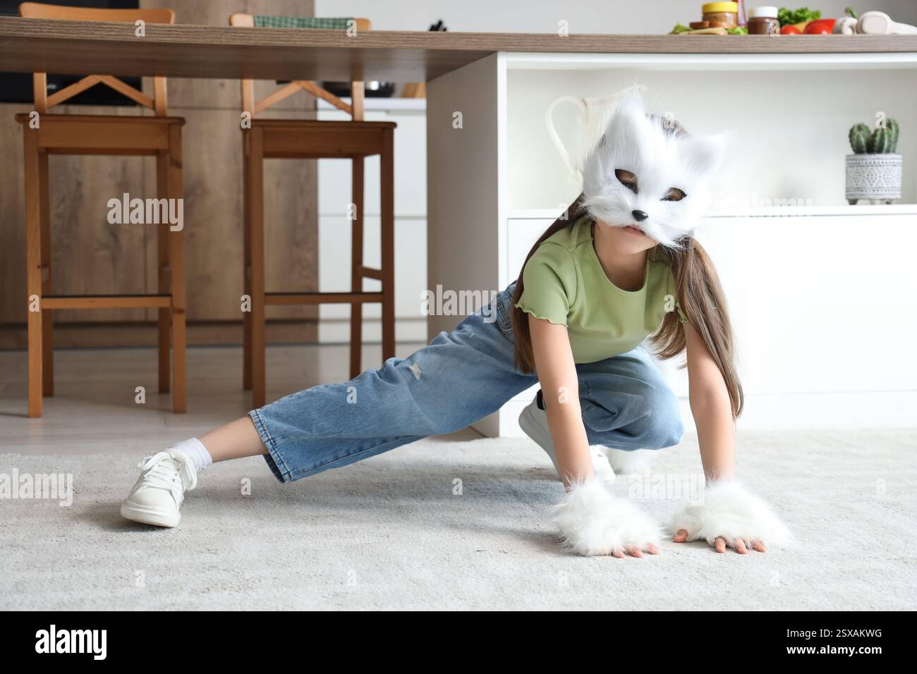 Quadrober girl in cat disguise playing at home Stock Photo - Alamy