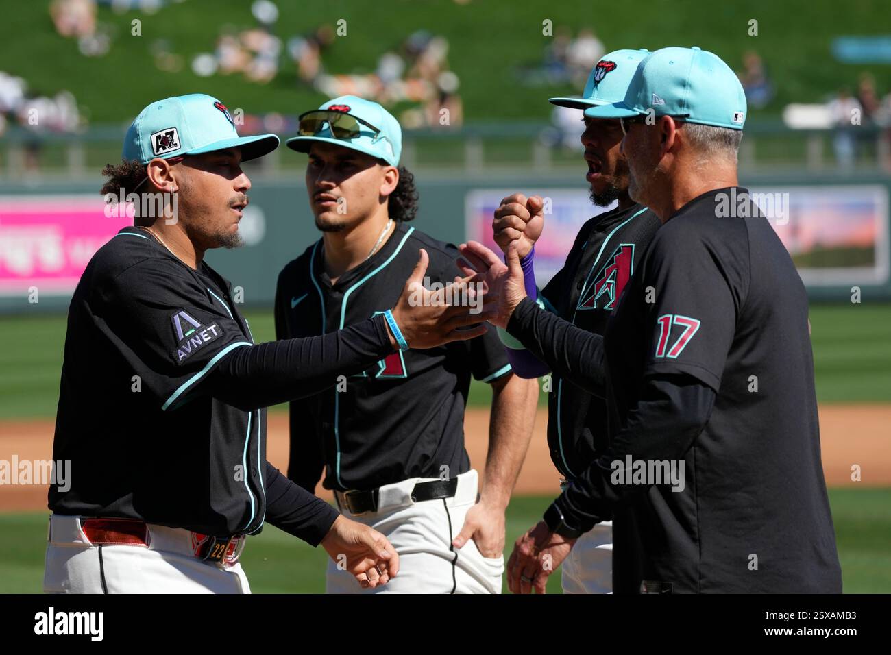 Arizona Diamondbacks first base Josh Naylor, left, shakes hands with ...