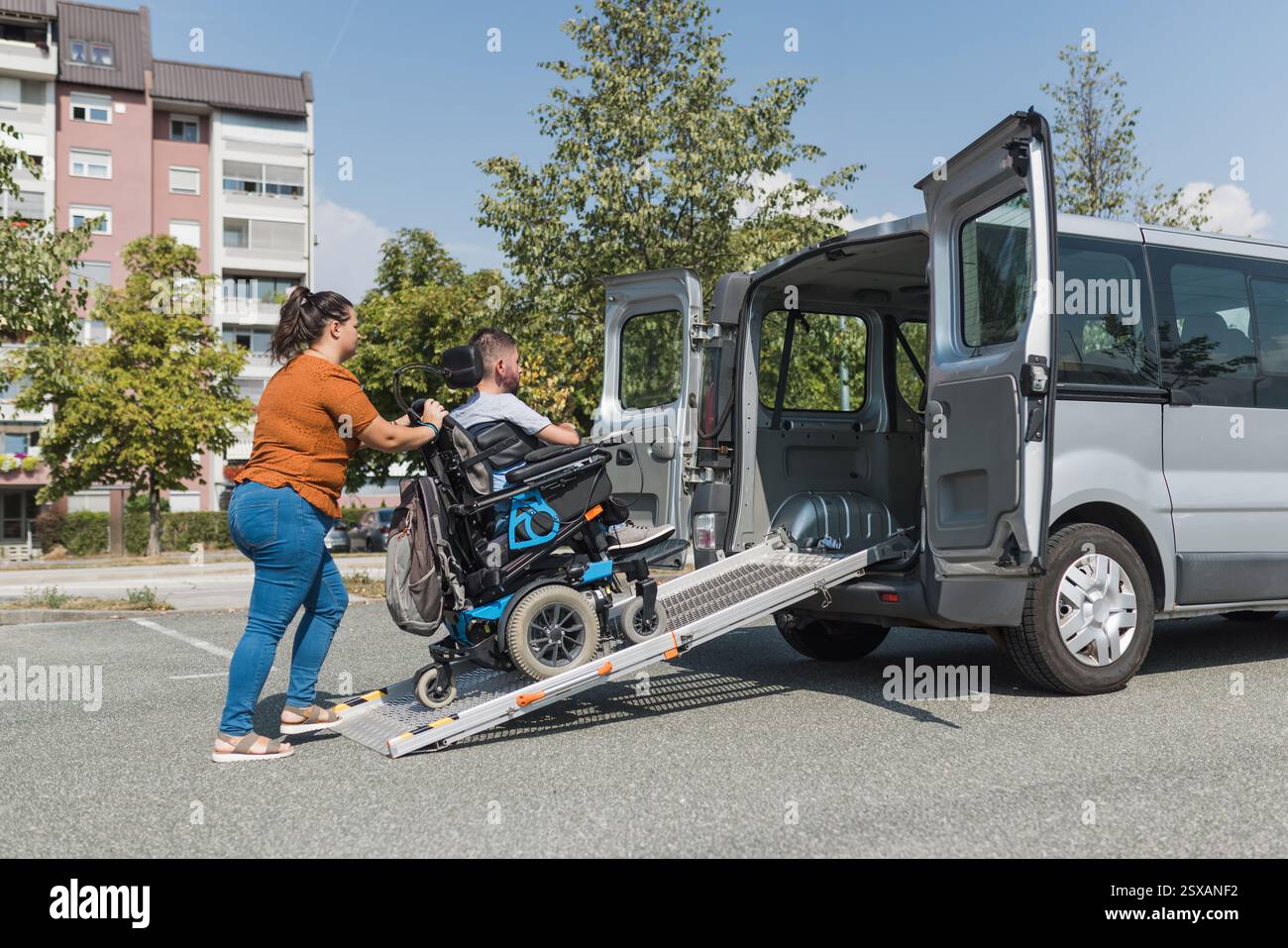 Man with a disability, a wheelchair user getting into an accessible ...