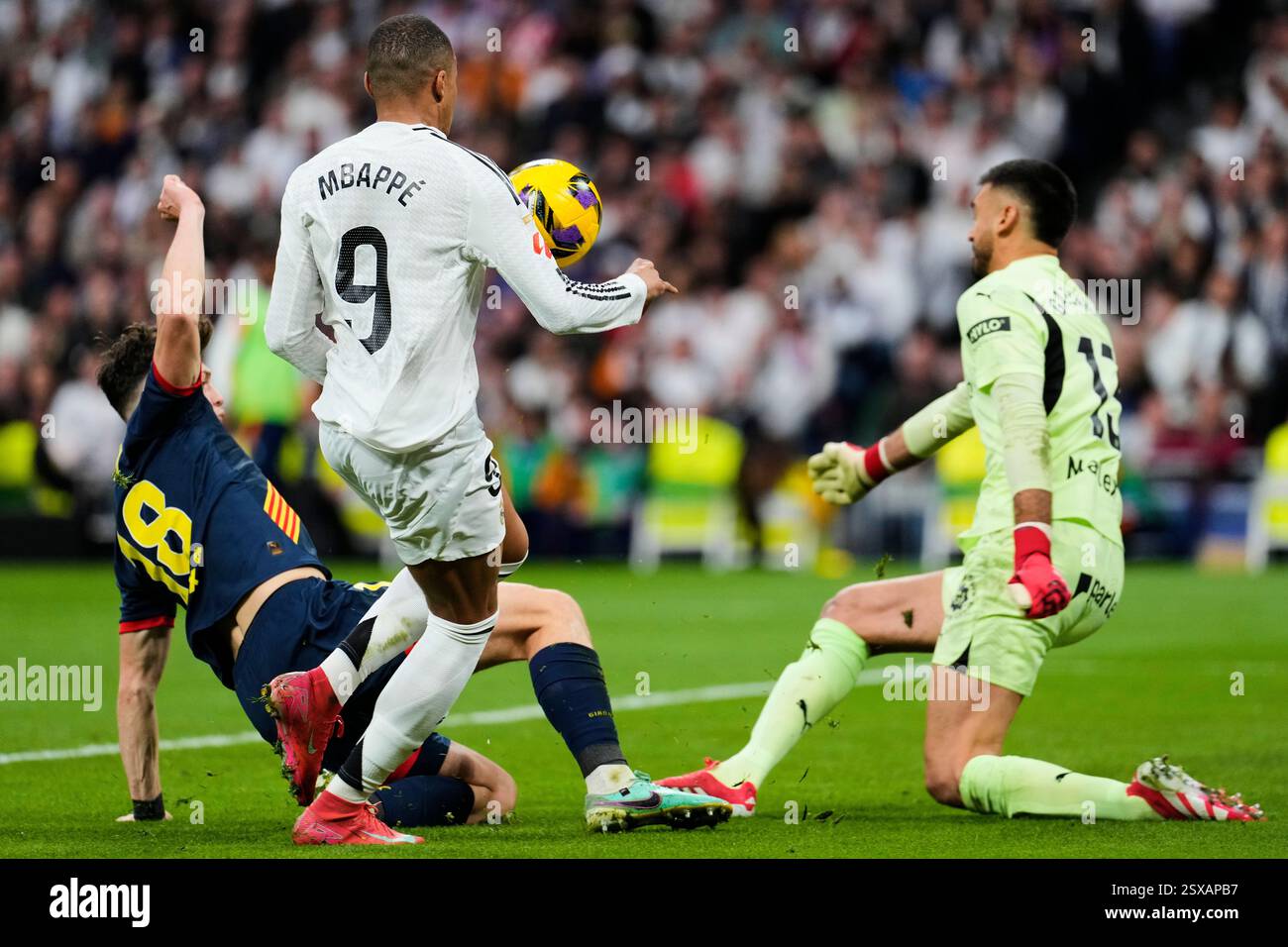 Kylian Mbappe of Real Madrid CF and Paulo Gazzaniga of Girona FC during ...