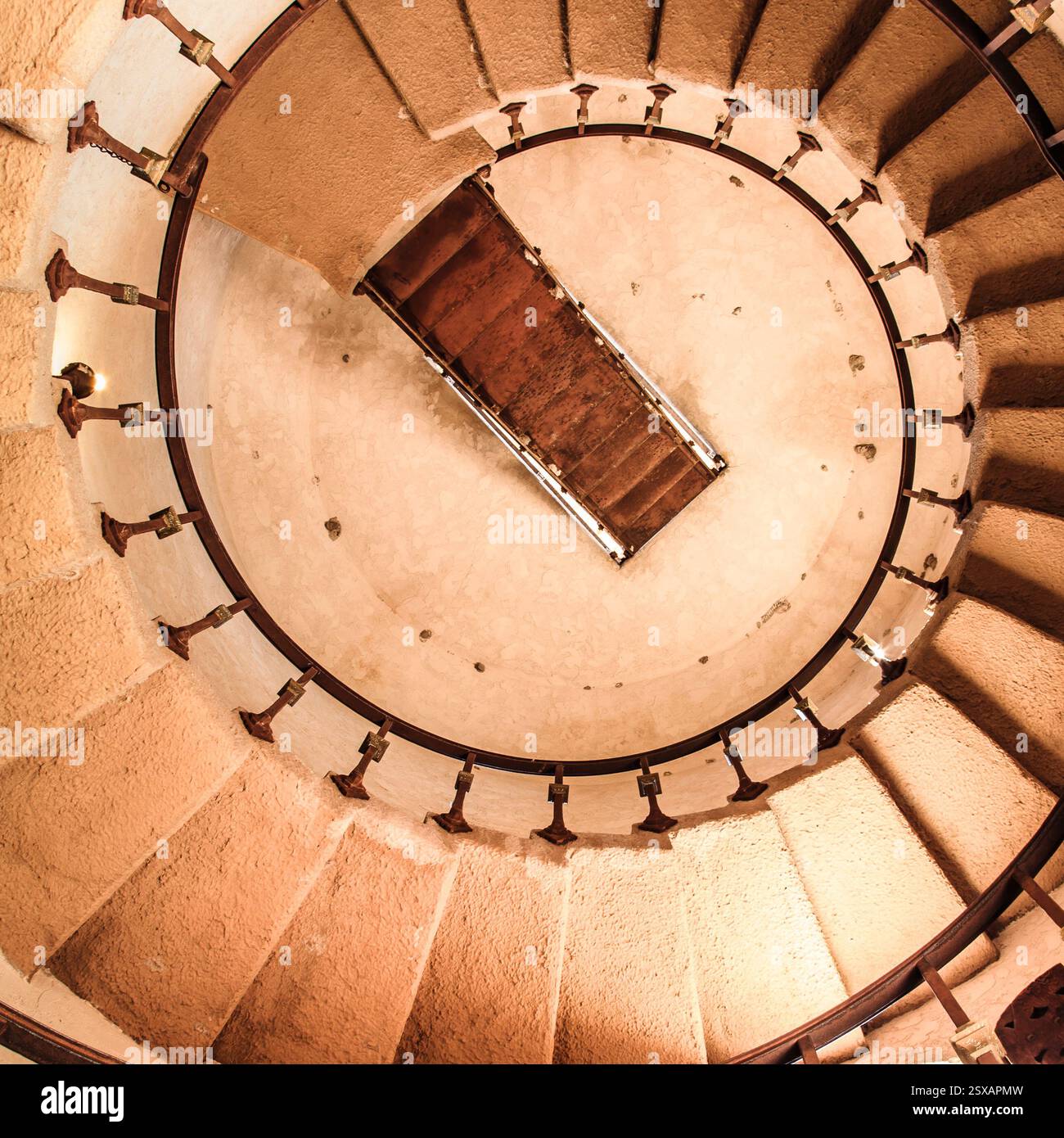 Spiral staircase with a wooden handrail. The staircase is made of wood ...