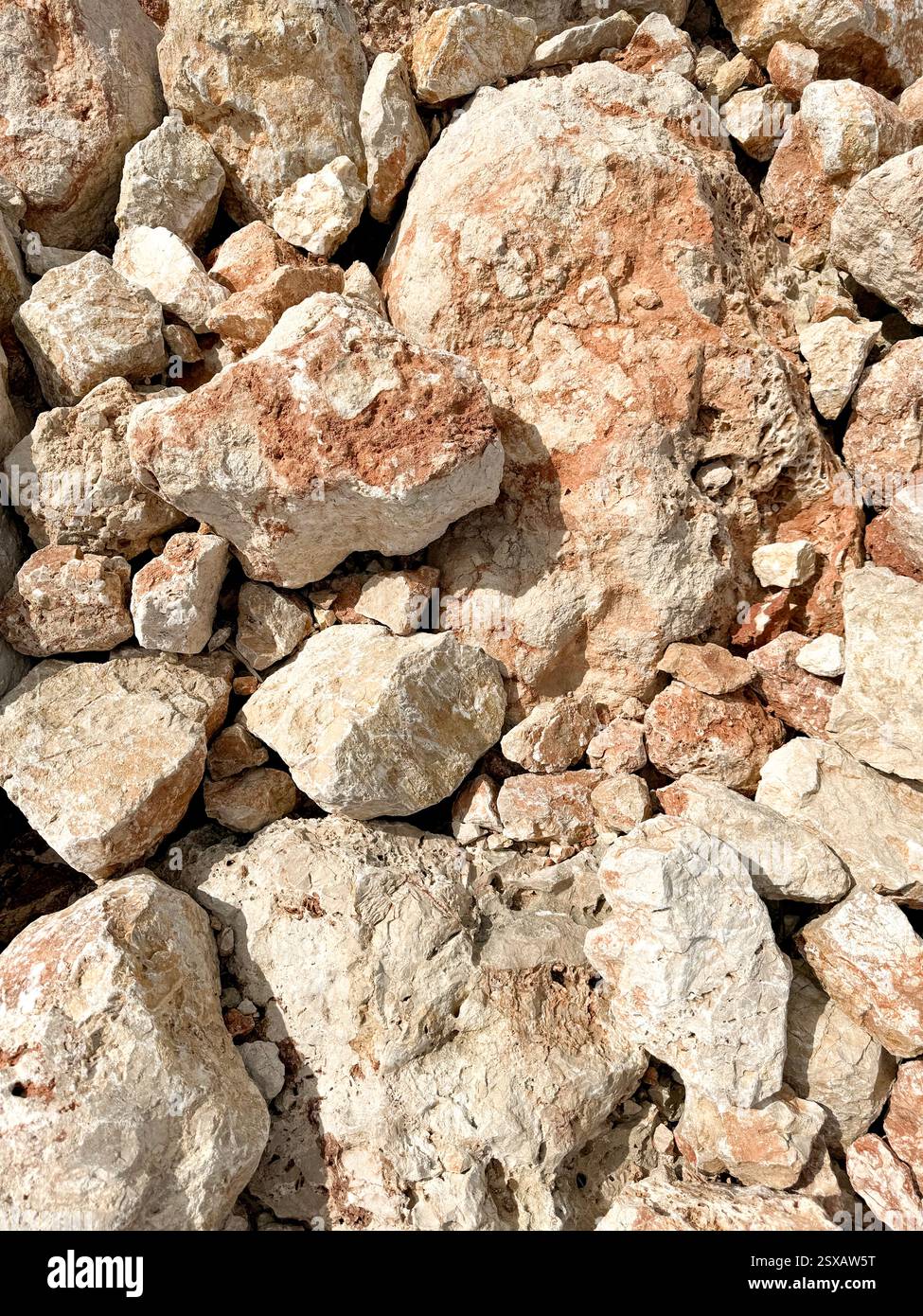 Colorful rocks scatter on the ground, reflecting sunlight by an active ...