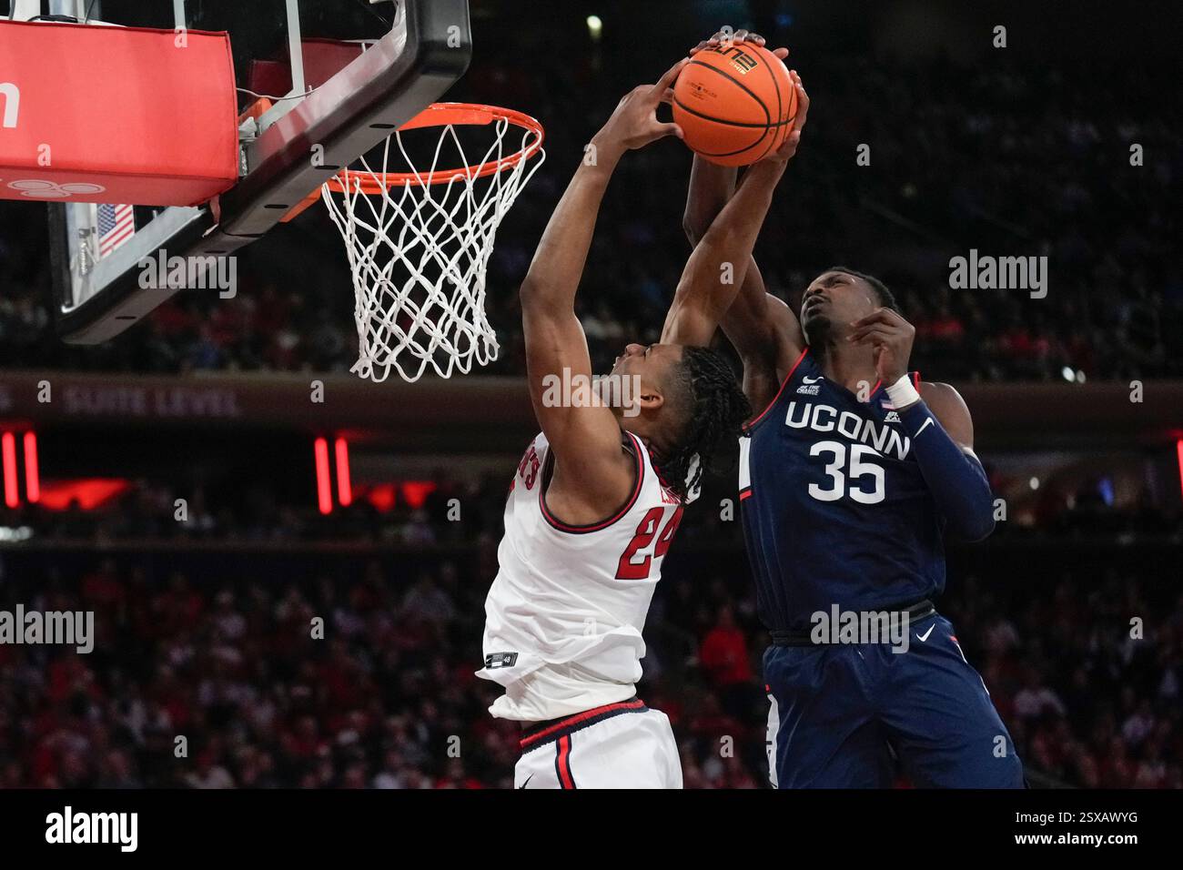 UConn's Samson Johnson, right, blocks a shot by St. John's Zuby Ejiofor ...