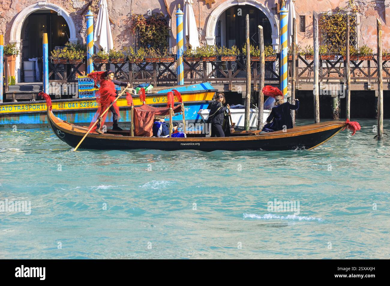 People in costume in a gondola on the Grand Canal during the carnival ...