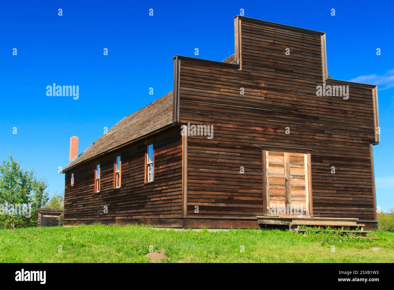 Large wooden building with a cross on the front. The building has a ...