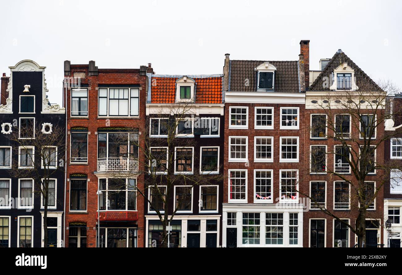 Row of colorful narrow dutch houses with gabled facades and large ...