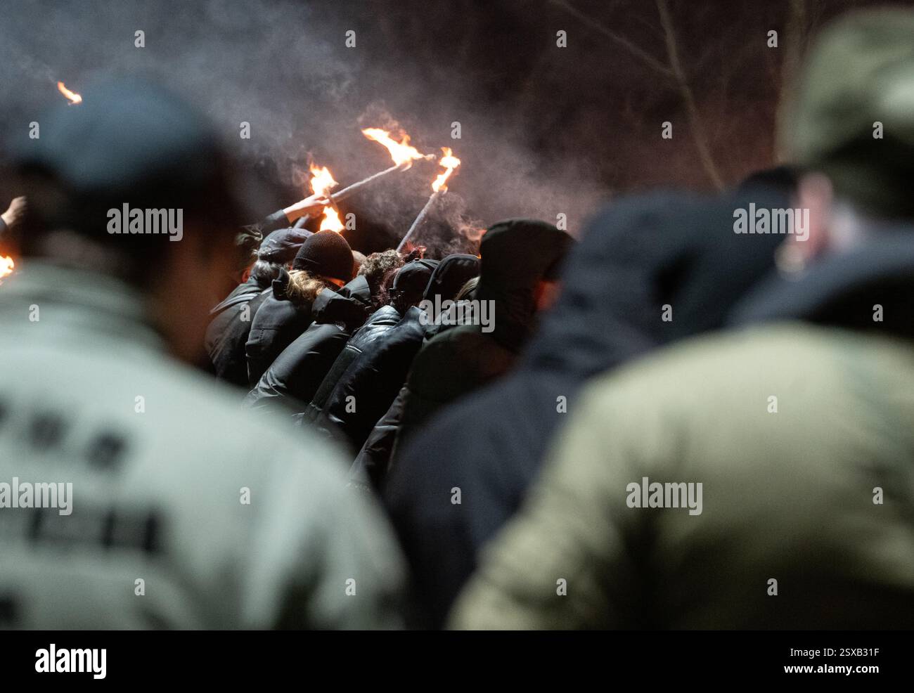 Pforzheim, Germany. 23rd Feb, 2025. Participants in a torchlight vigil ...