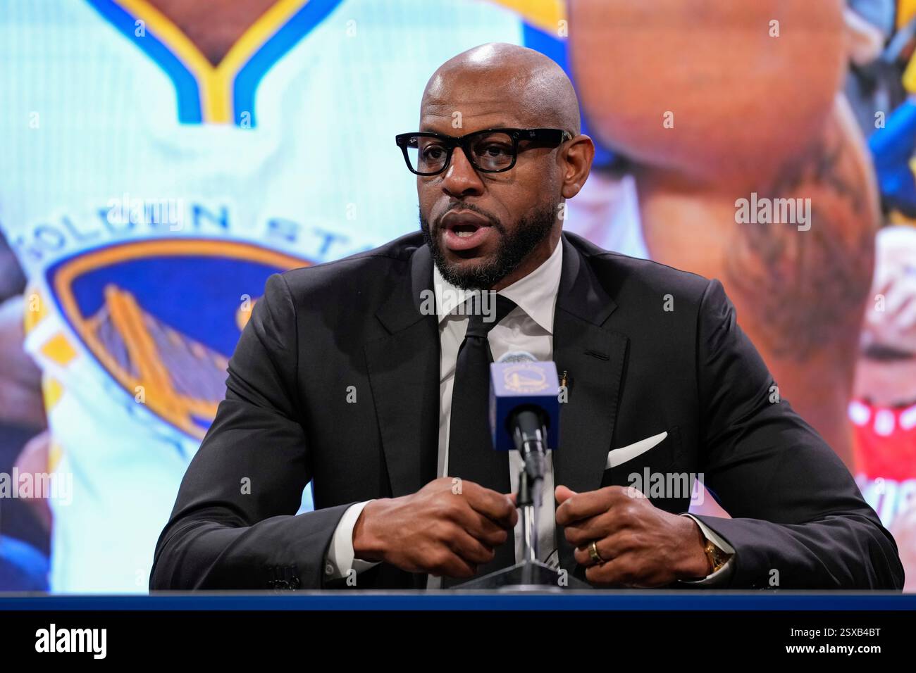 Former basketball player Andre Iguodala, right, talks to reporters ...