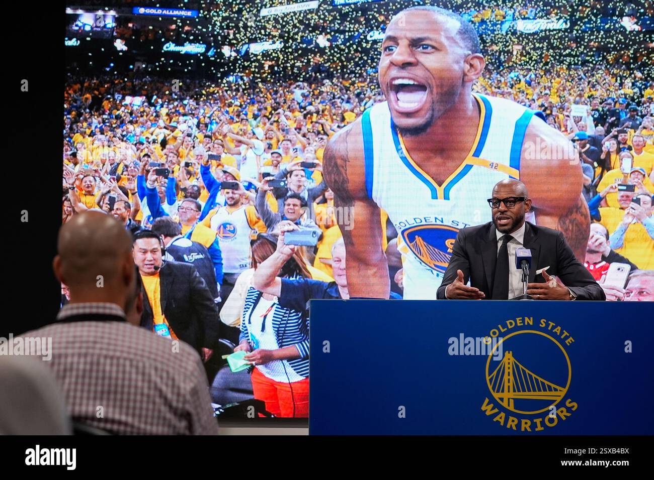 Former basketball player Andre Iguodala, right, talks to reporters ...