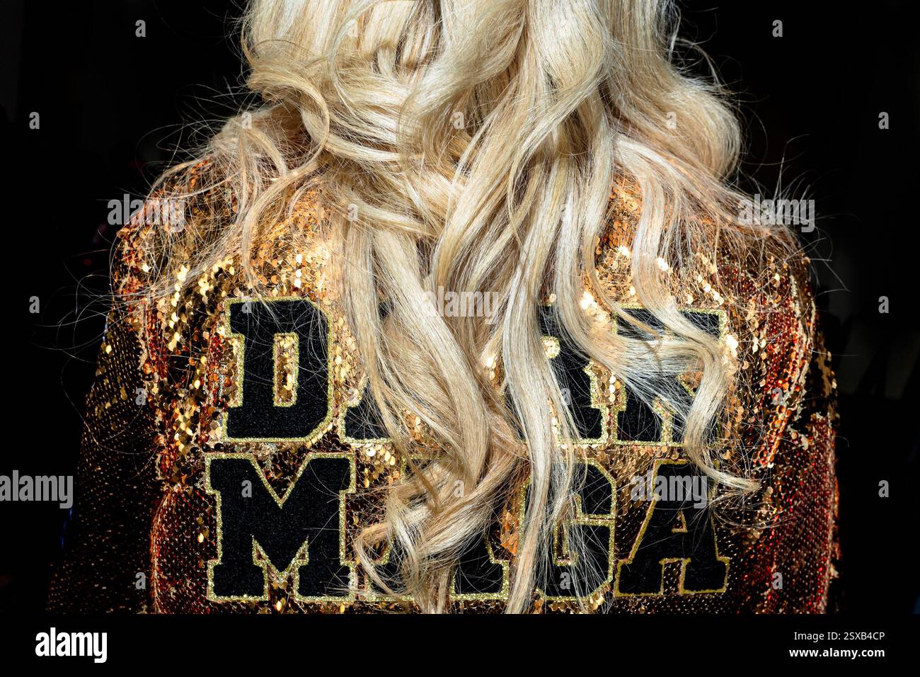 An attendee wears a 'Dark MAGA' sequined jacket at CPAC 25 Day 3, in ...