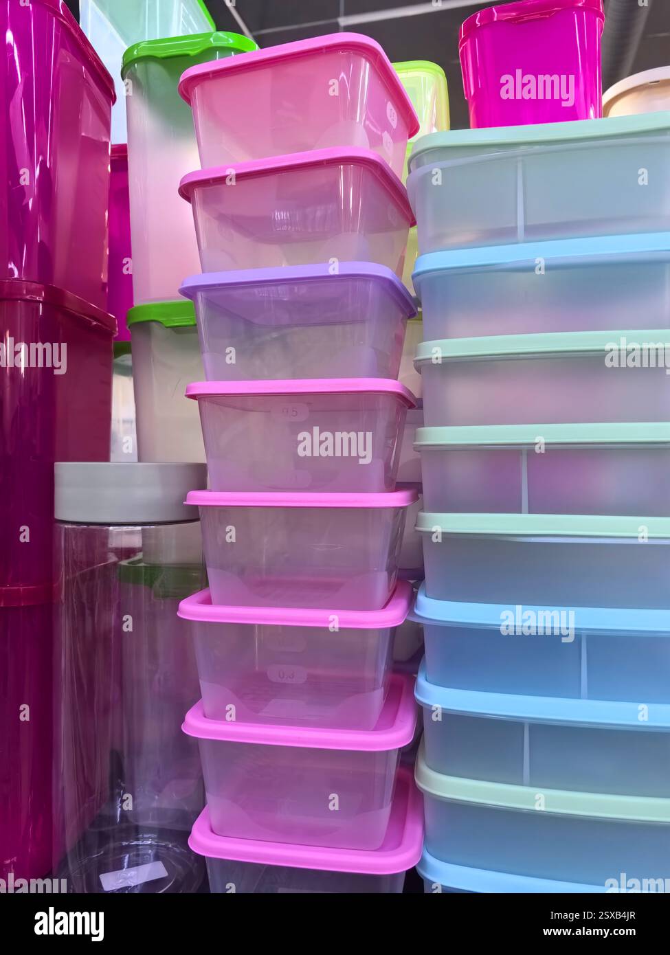 Brightly colored plastic storage containers are stacked in an organized ...