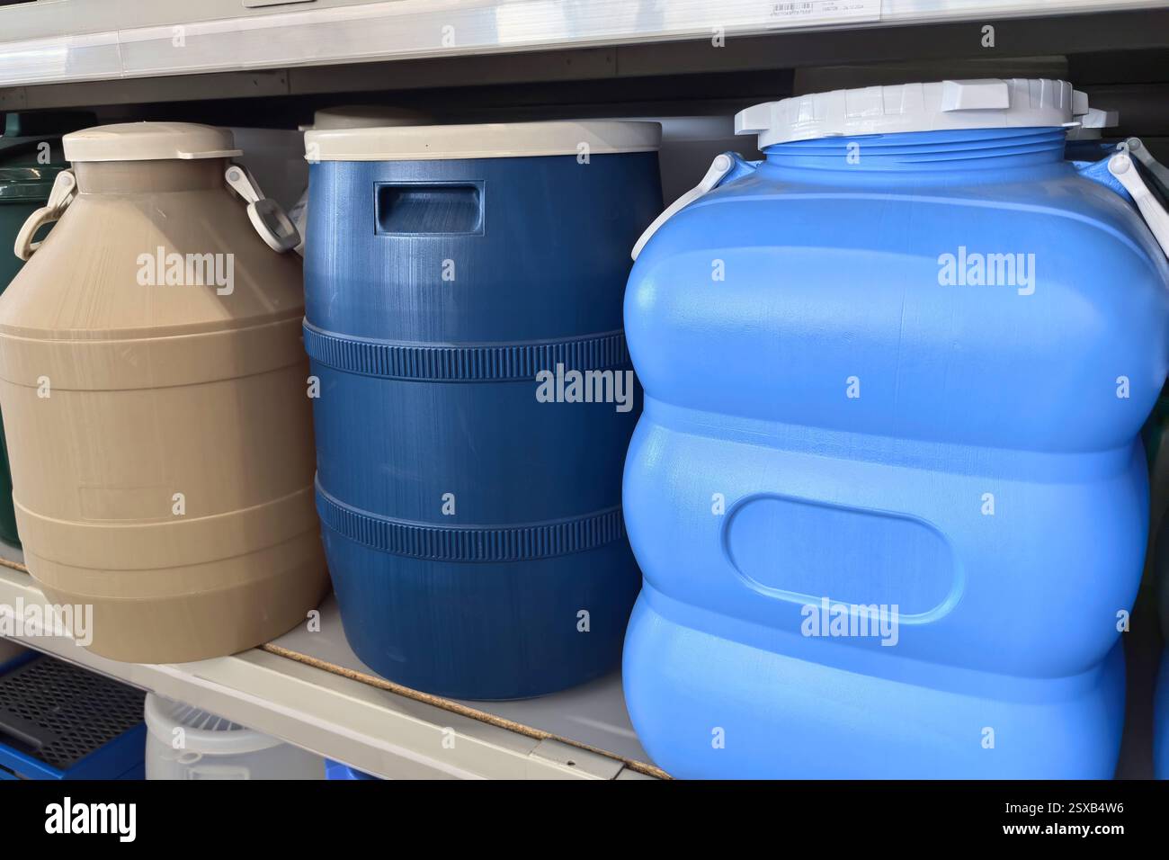 Colorful plastic containers are neatly arranged on a shelf in a store ...