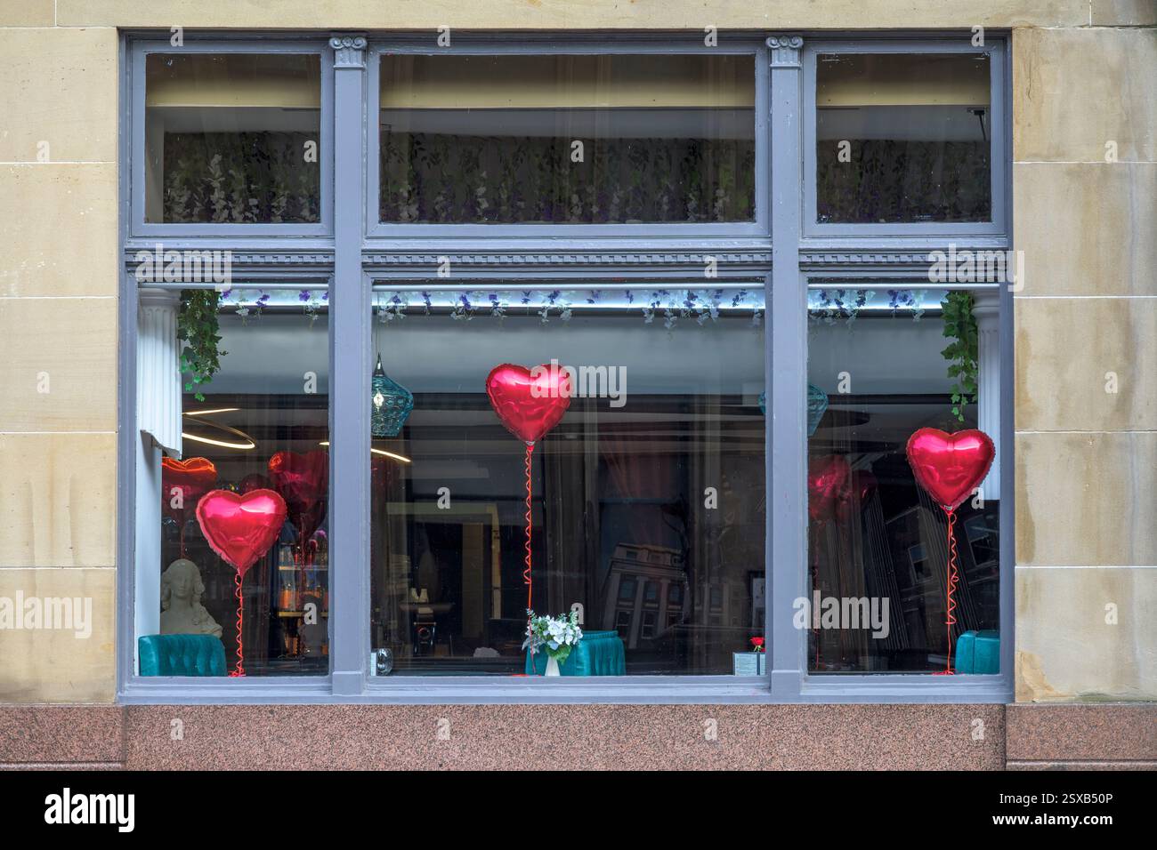 Three heart shape balloons in a restaurant window on Valentines Day ...