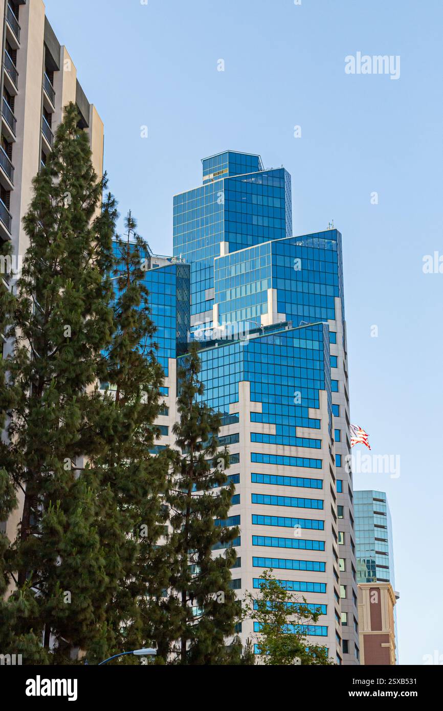 Modern city skyline glows under warm sunset light. Golden hues of ...