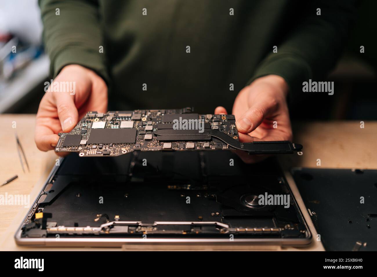 Electronic technician carefully handling delicate computer motherboard ...