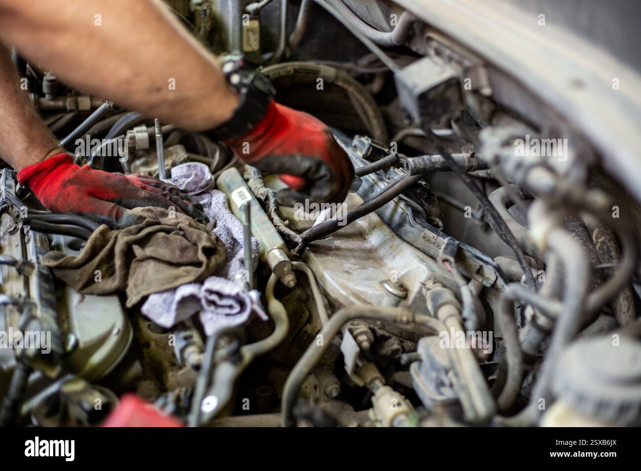 Car repair. Mechanic removes valve covers of the timing mechanism Stock ...