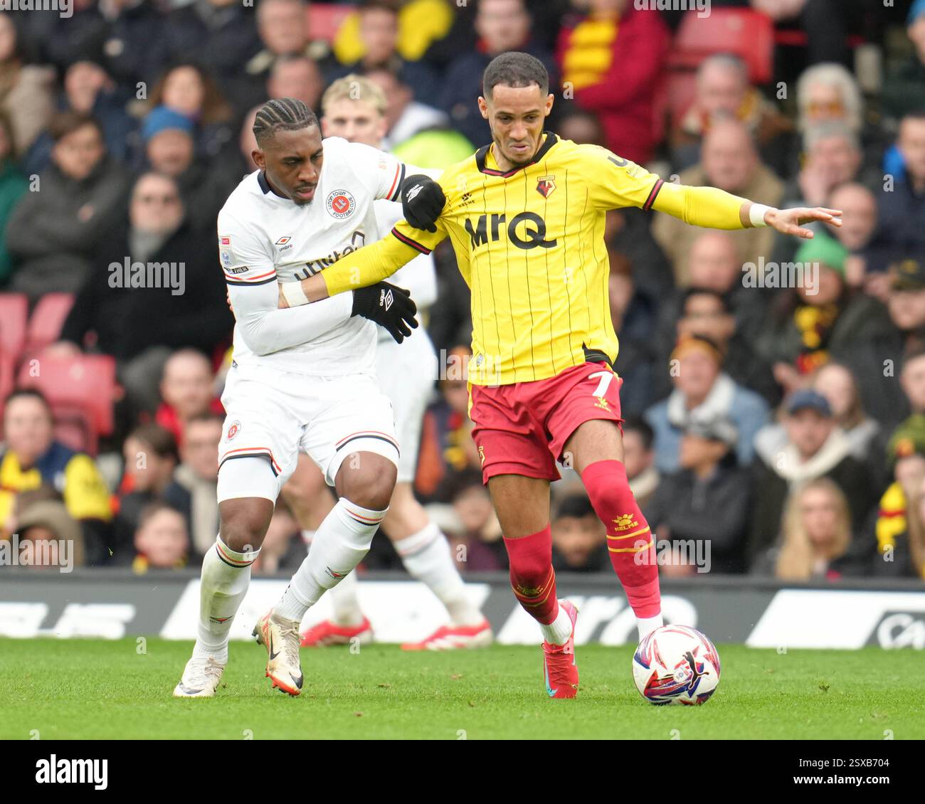 Thomas Ince of Watford holds the ball off from Amari'i Bell of Luton ...