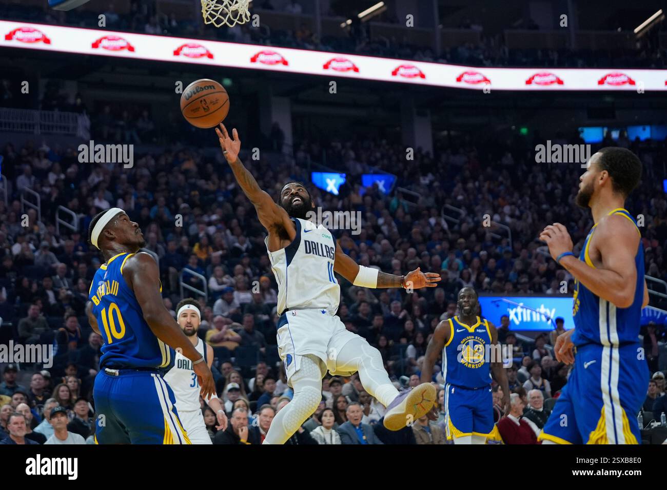 Dallas Mavericks guard Kyrie Irving, center, shoots next to Golden ...