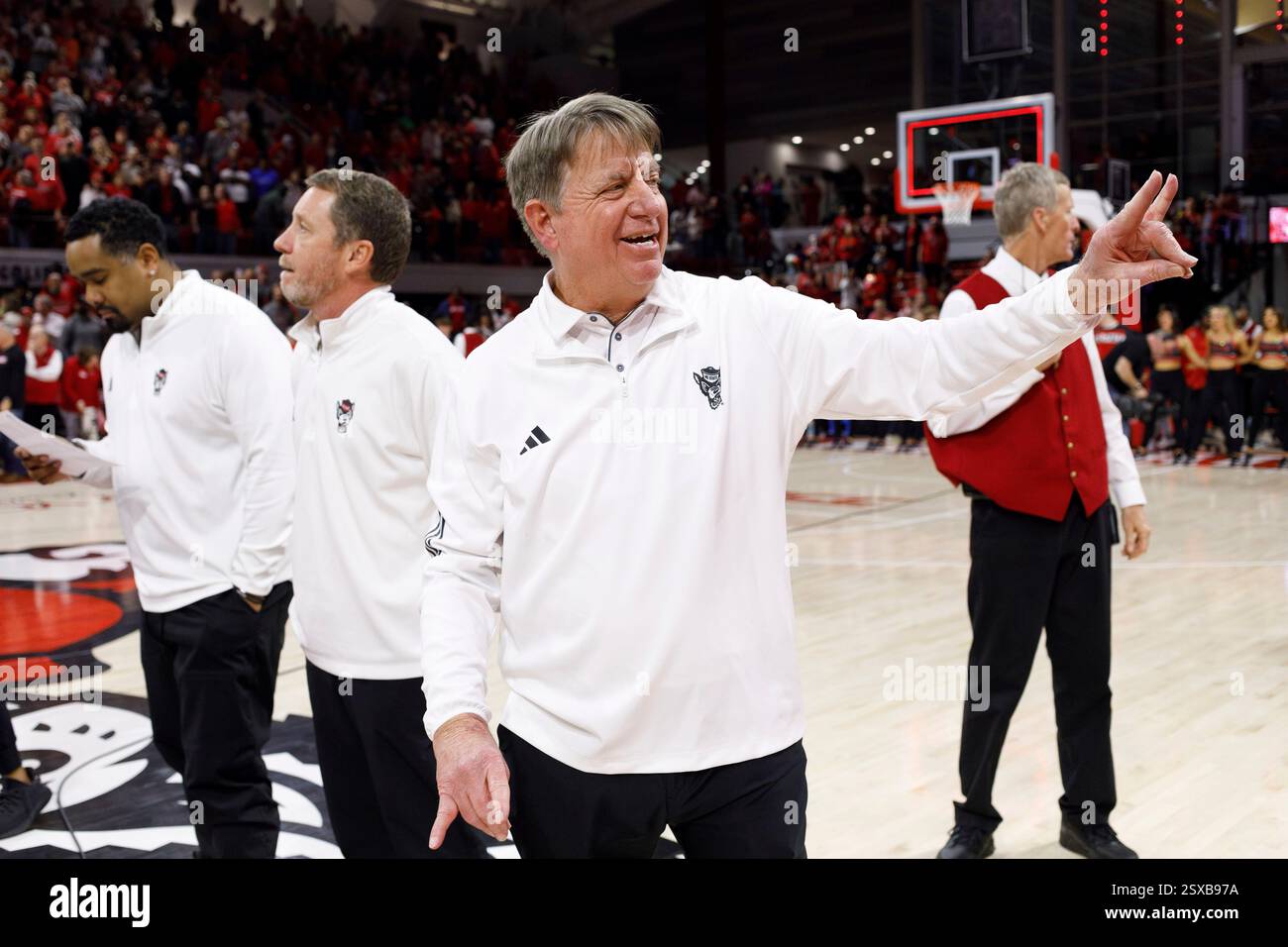 North Carolina State head coach Wes Moore, center, gestures to fans ...
