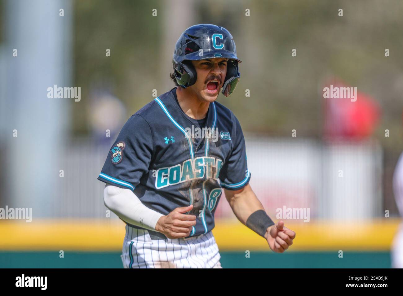 Coastal Carolina infielder Dean Mihos (8) runs to third during an NCAA ...