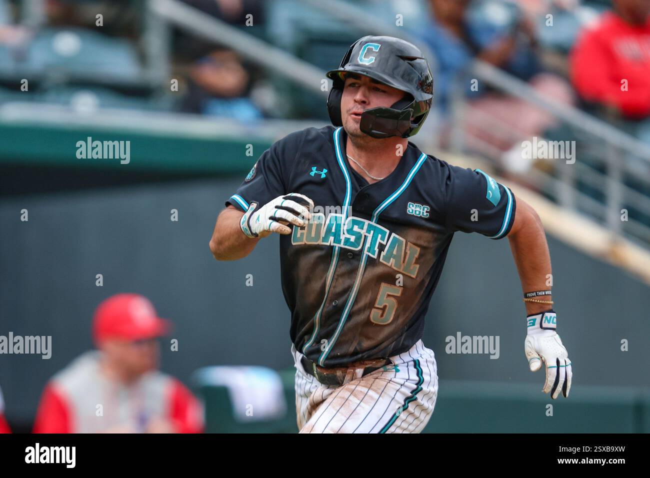 Coastal Carolina infielder Walker Mitchell (5) runs to home plate ...