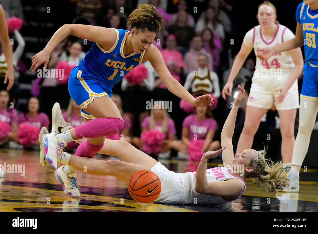 Iowa guard Kylie Feuerbach, bottom right, is fouled by UCLA guard Kiki ...