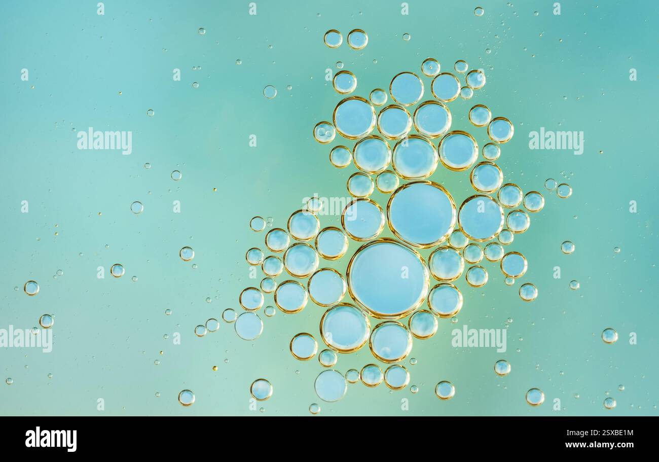 Close up Transparent water bubbles rising in a light blue liquid ...