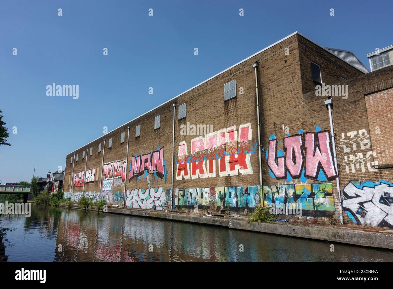 graffiti all over a disused brick building on the Grand Union Canal ...