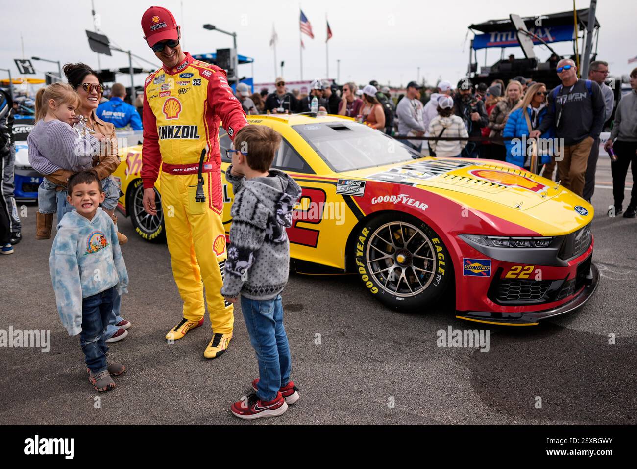 Joey Logano and family speak before a NASCAR Cup Series auto race ...