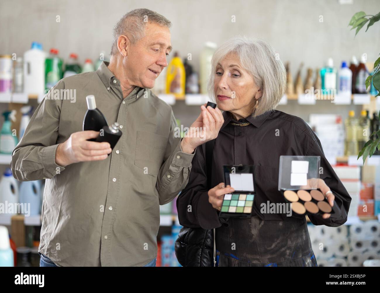 Husband and wife choose cosmetics and perfume together in supermarket ...