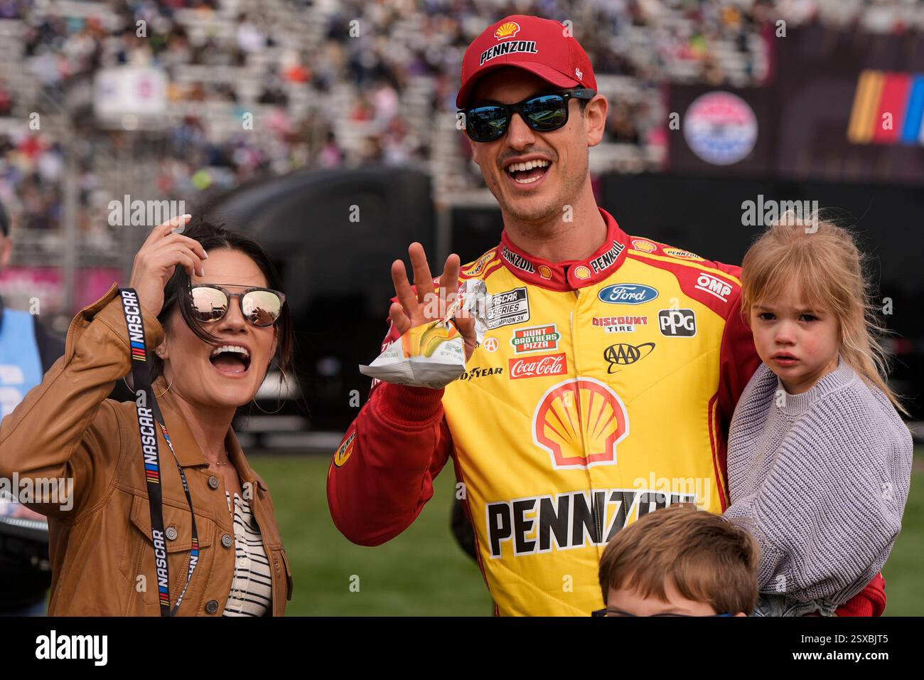 Joey Logano speaks with crew with his wife Brittany and their daughter ...