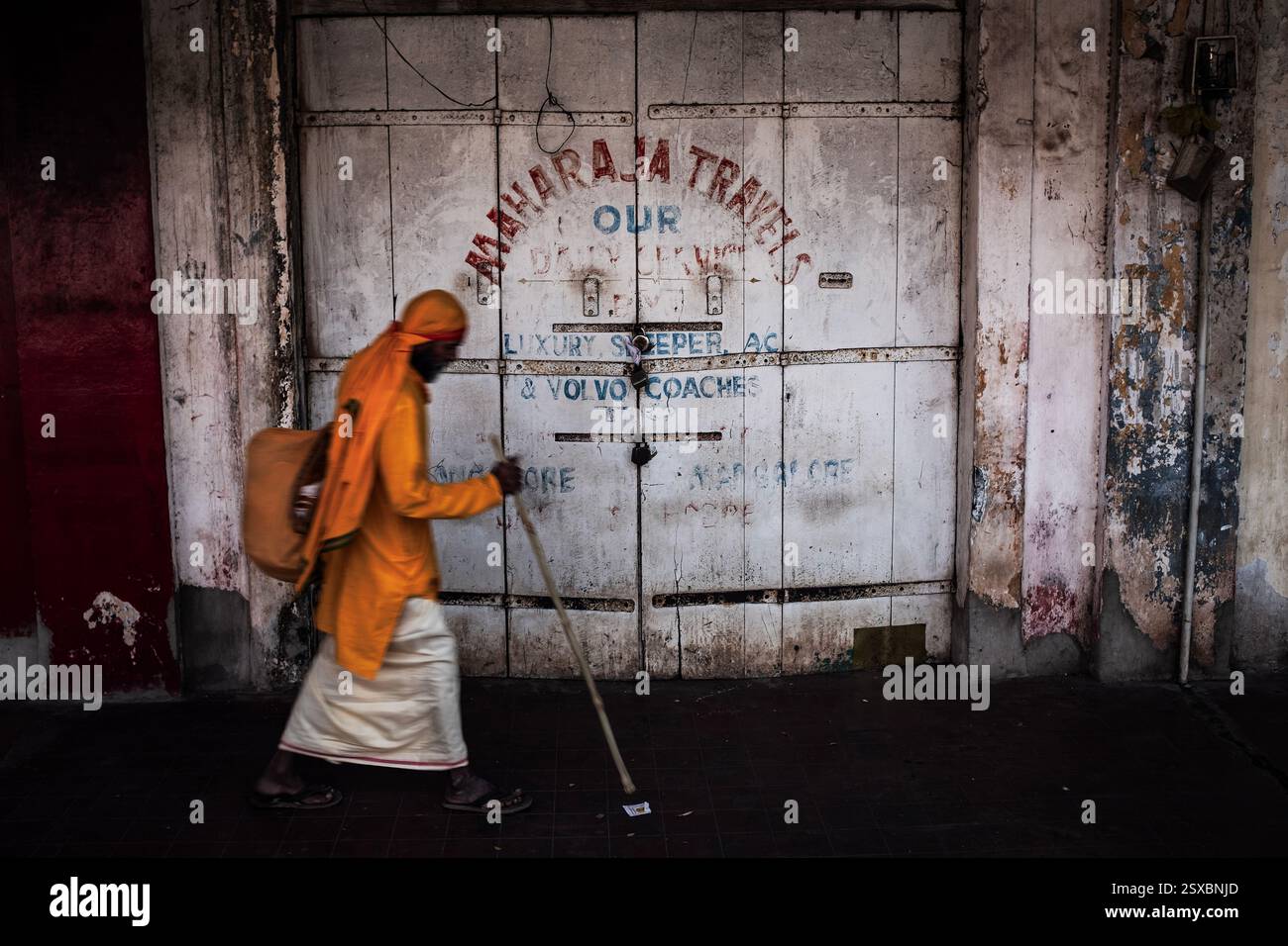 Indian man in traditional dress walking on the street in Margao, Goa ...