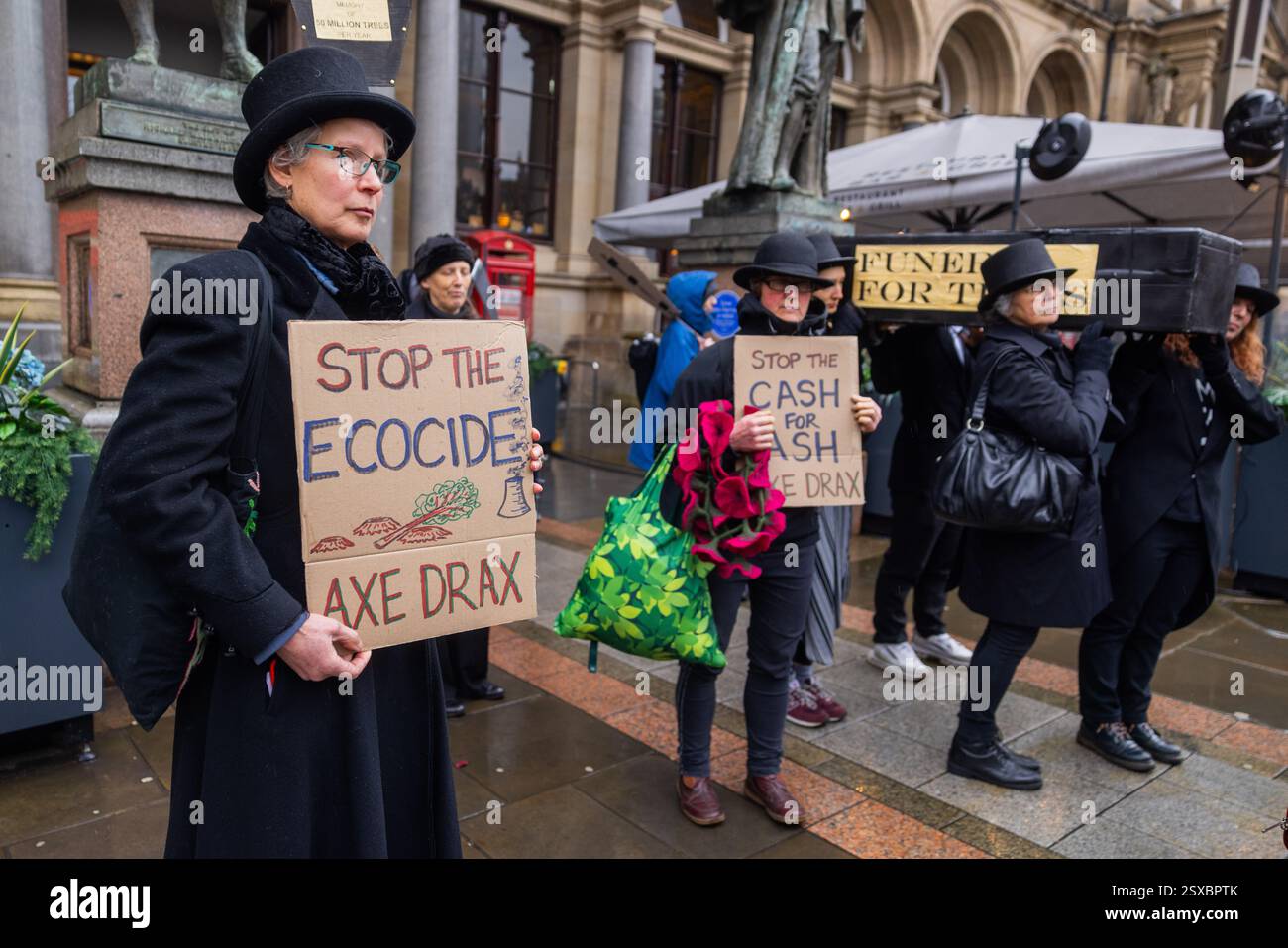 Leeds, UK. 23 FEB, 2025. Mourner holds "Stop the Ecocide" placard as a ...