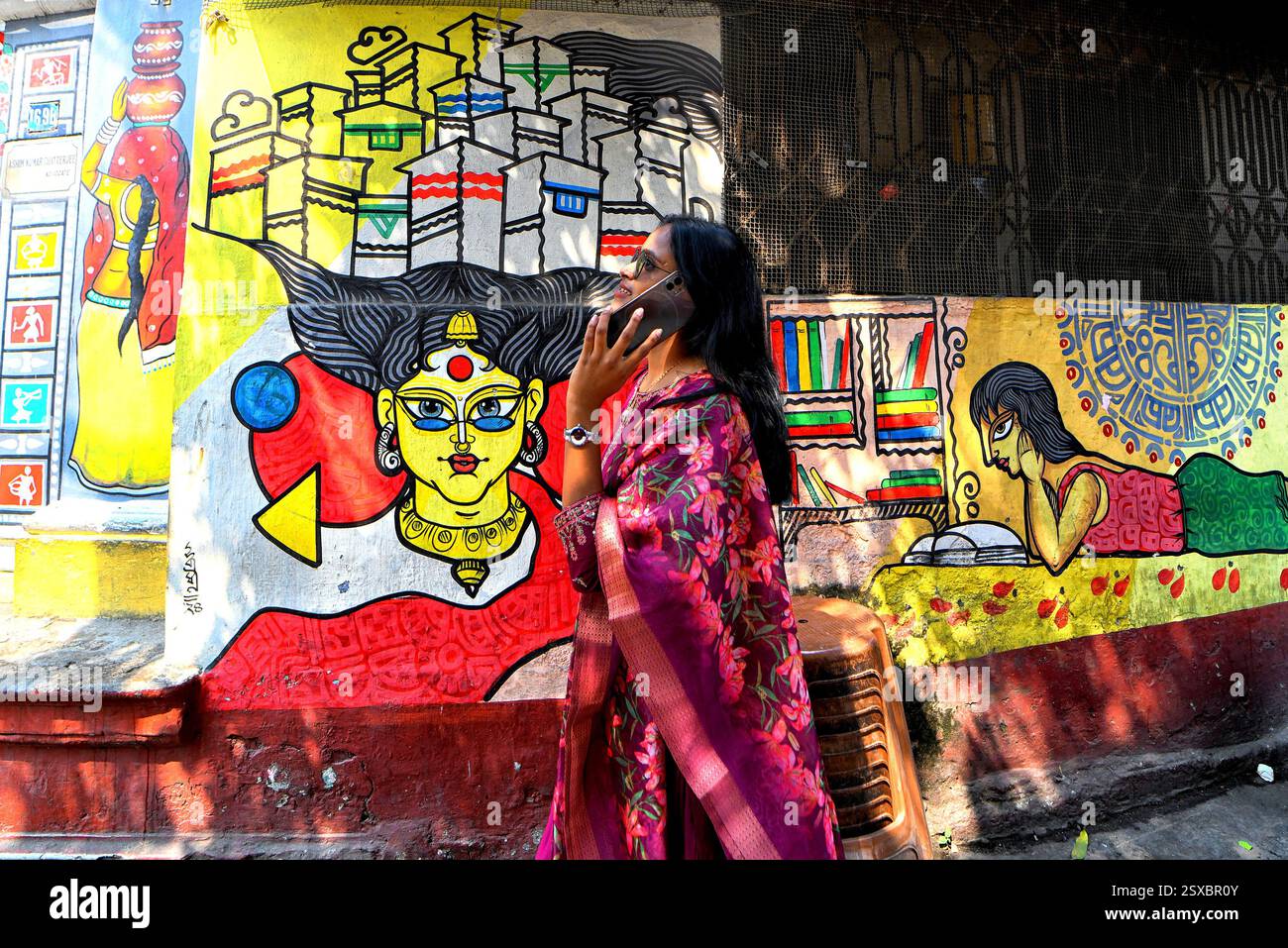 Model Tithi Das talks on Mobile phone in front of a Graffiti wall of ...