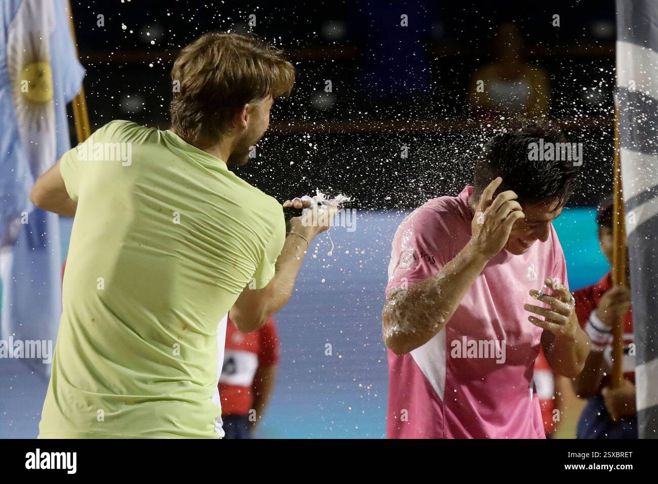 France's Alexandre Muller sprays champagne on Argentina's Sebastian Baez after the final match ...