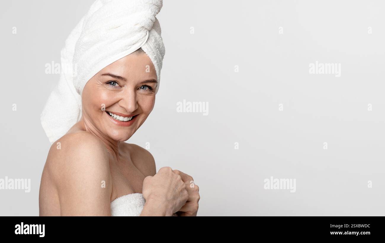 After Spa. Portrait Of Happy Beautiful Mature Woman With Towel On Head Stock Photo - Alamy